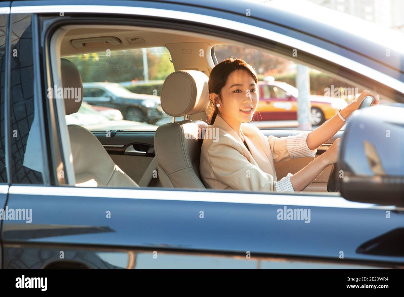 Driving the beautiful young woman Stock Photo - Alamy