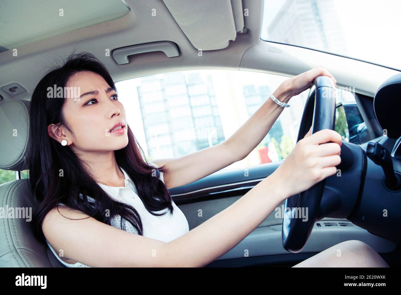 The angry young woman driving a car Stock Photo - Alamy