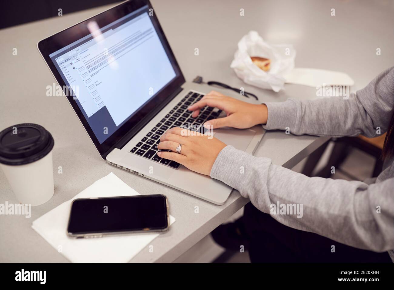 Asian businesswoman eating at computer hi-res stock photography and ...