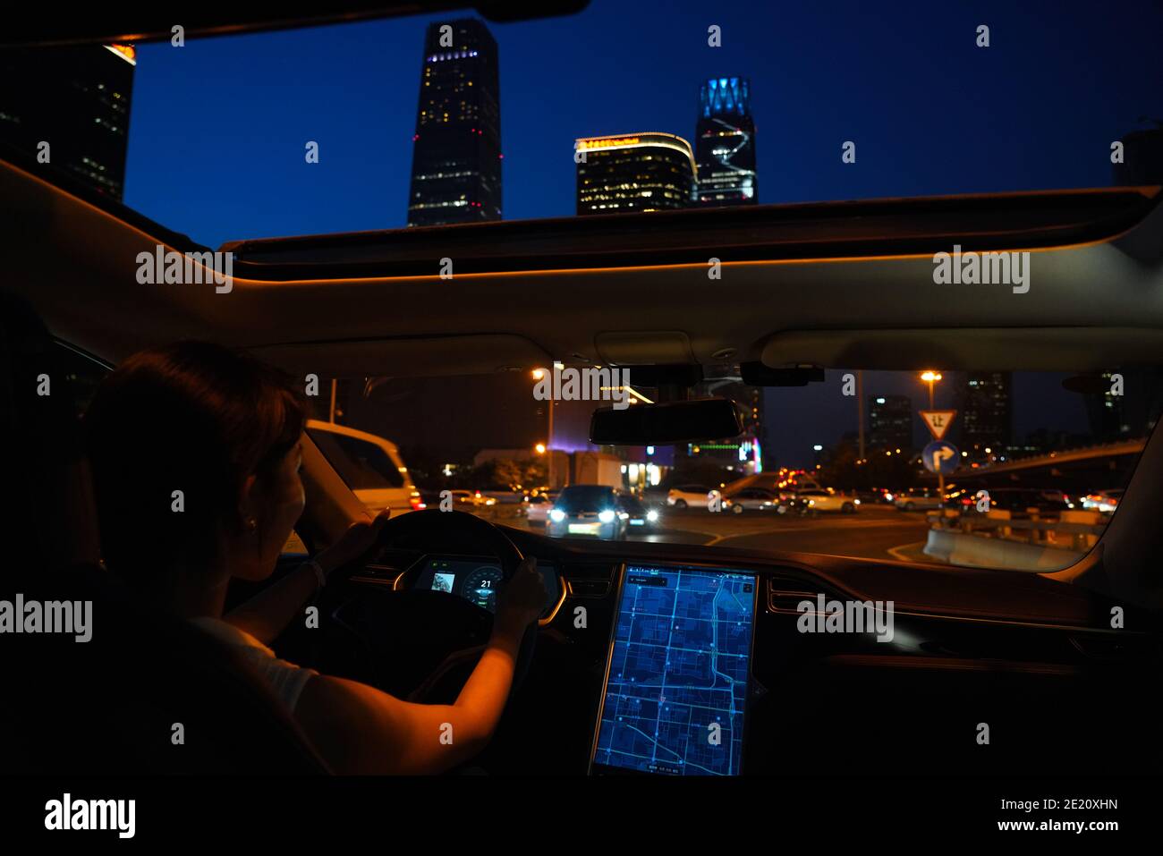 Driving at night young woman Stock Photo - Alamy