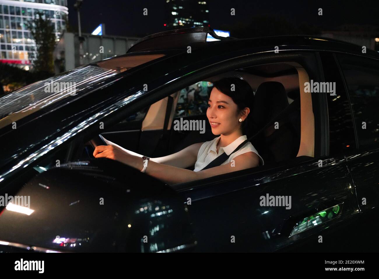 Driving at night young woman Stock Photo - Alamy