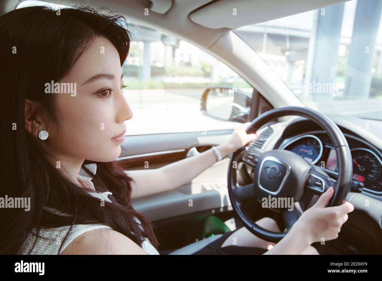 Driving the beautiful young woman Stock Photo - Alamy