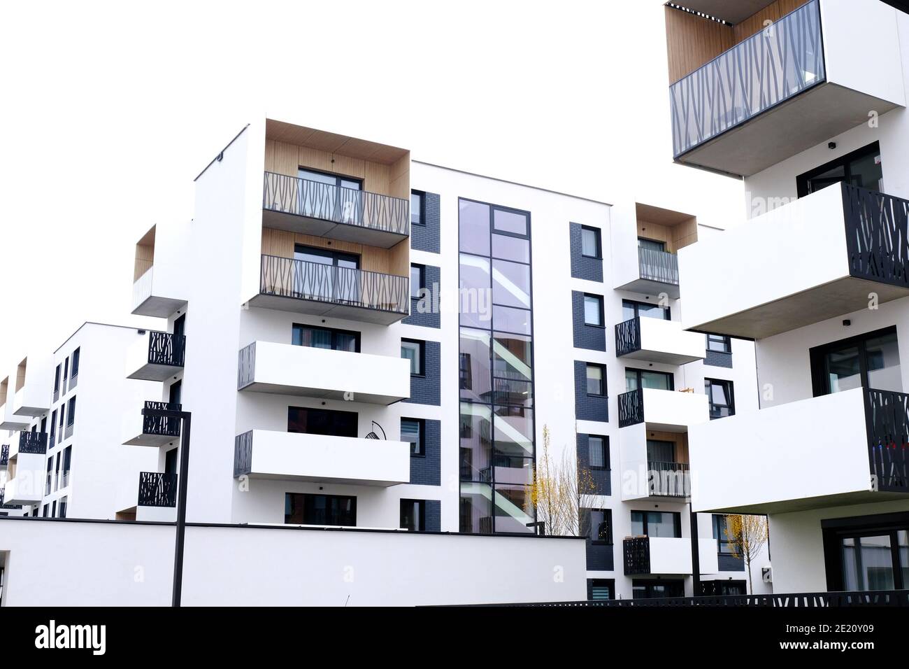 Facade of a modern apartment buildings with balcony and white walls. No ...