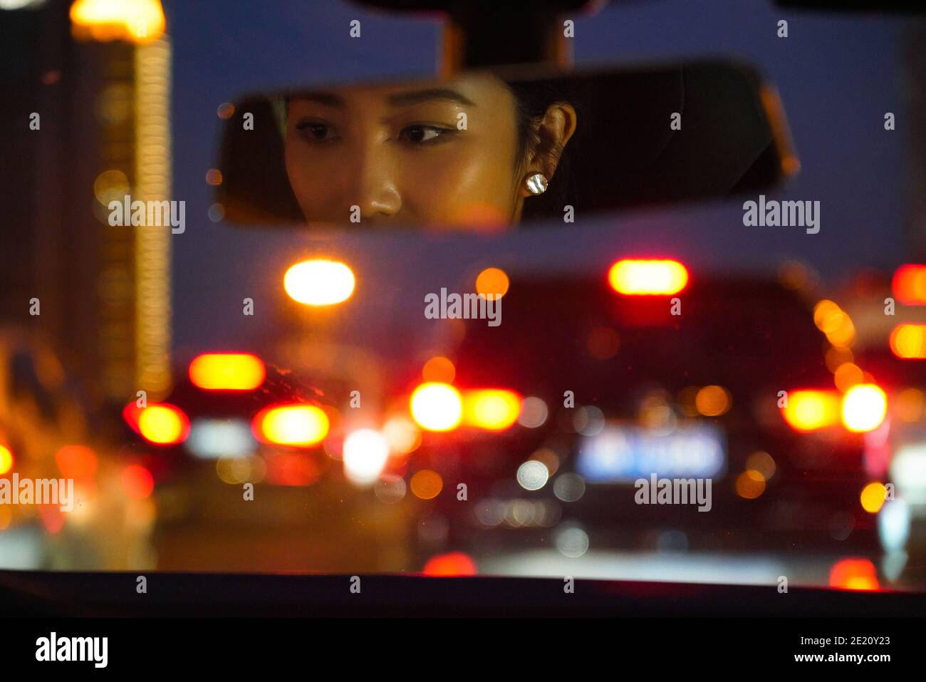 Car rearview mirror display of young women Stock Photo - Alamy