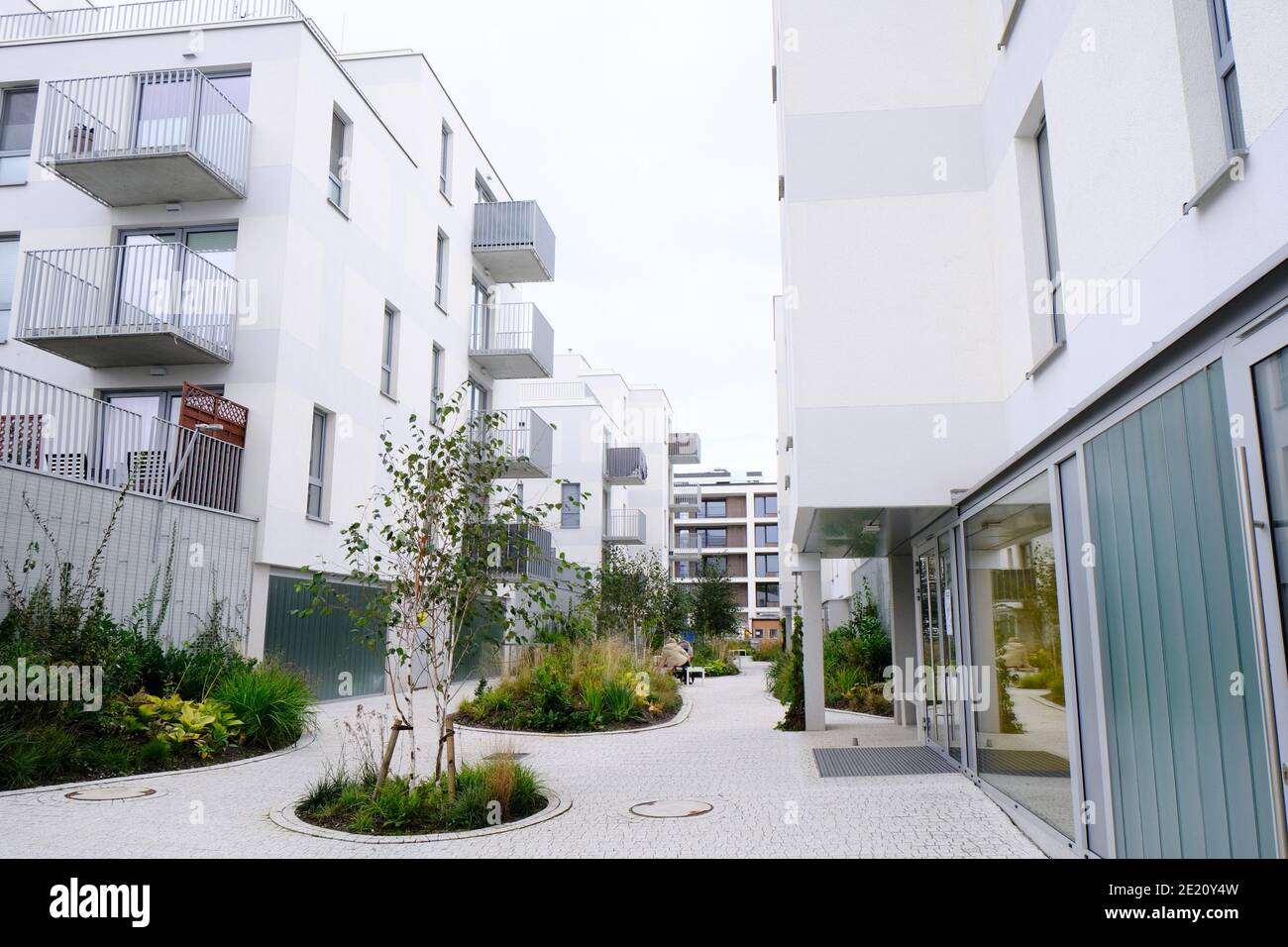 Sidewalk in a cozy courtyard of modern apartment buildings condo with ...