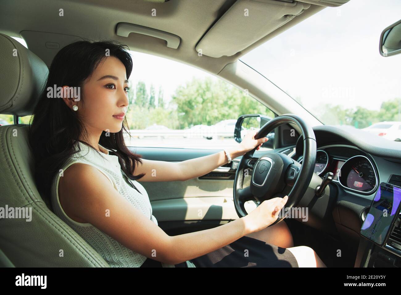 Driving the beautiful young woman Stock Photo - Alamy