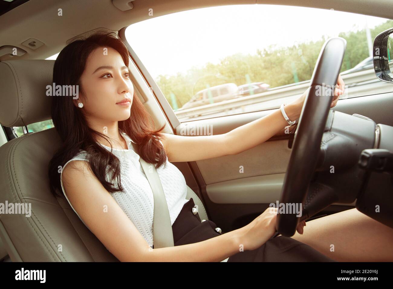 A beautiful young woman driving a car Stock Photo - Alamy