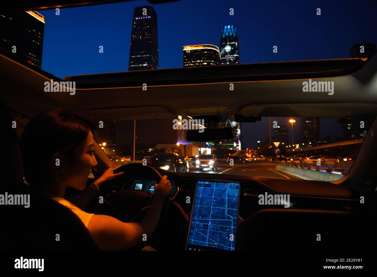 Driving at night young woman Stock Photo - Alamy