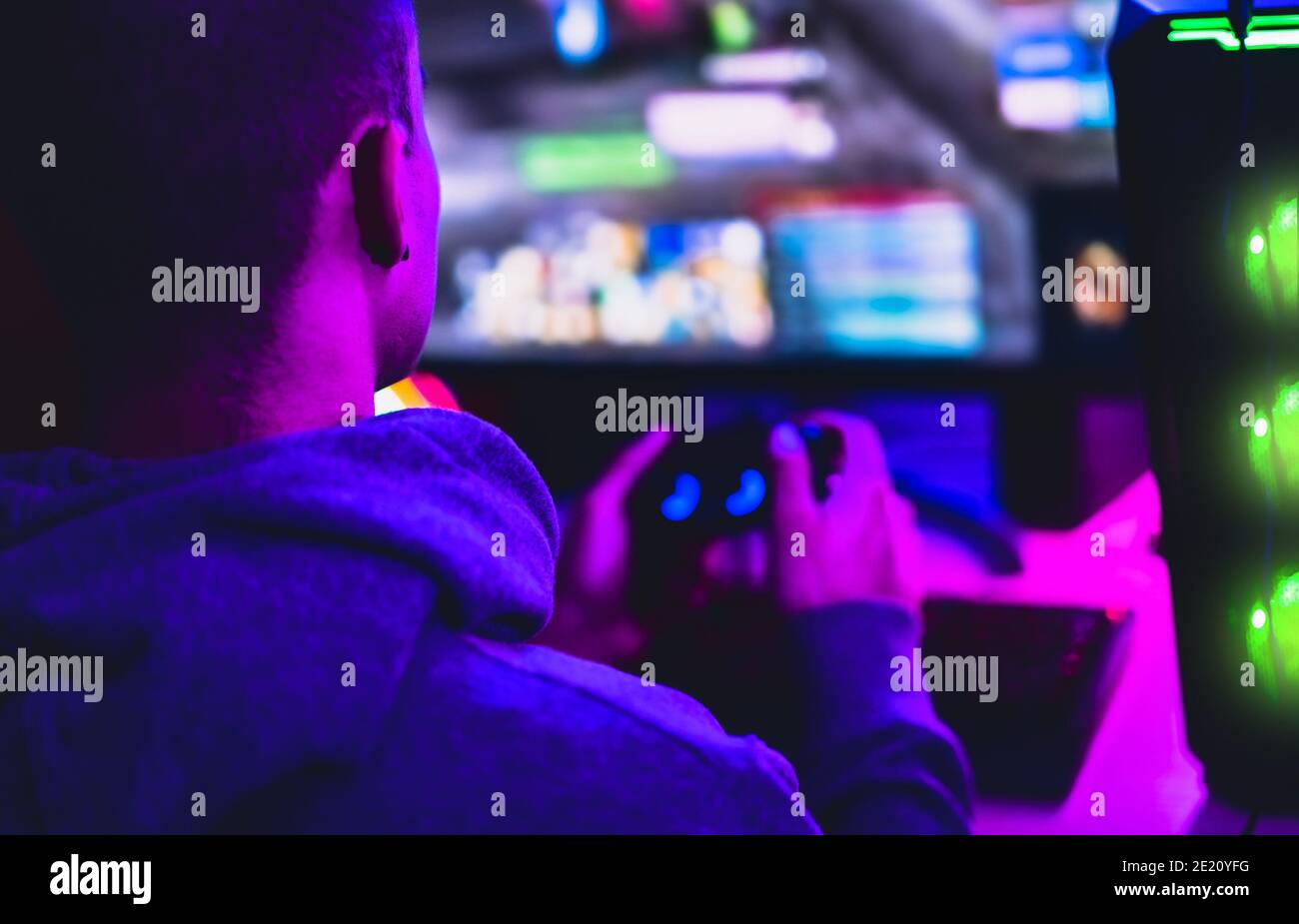 Young gamer playing online video games while streaming on social media ...