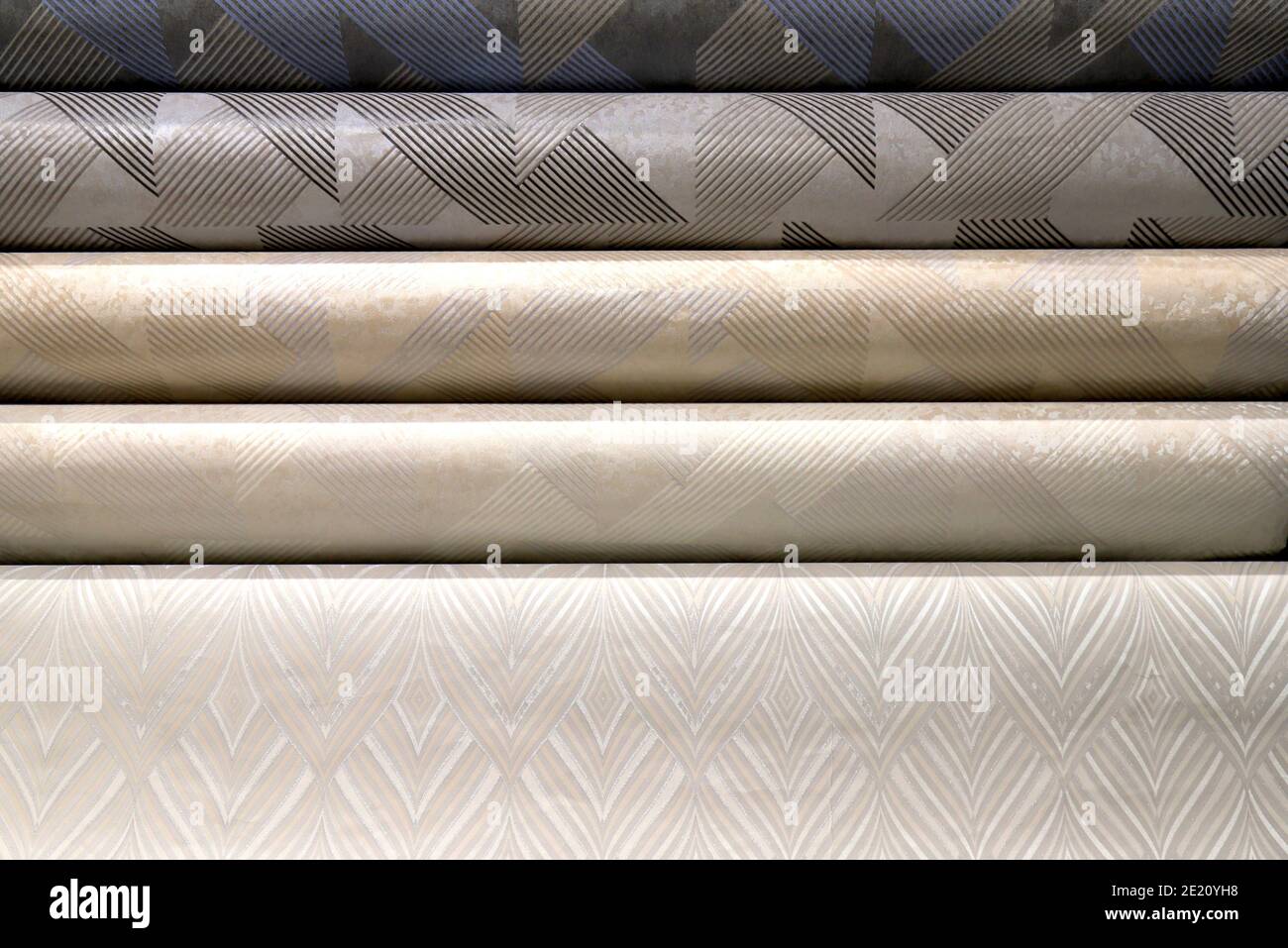 Rolled up rolls of vinyl wallpaper. Different textures and colors, as ...