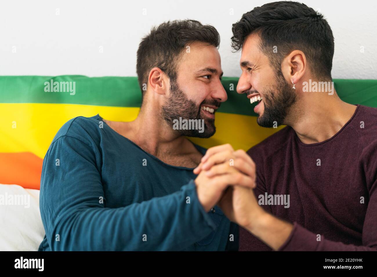 Happy gay couple having tender moments in bedroom - Homosexual love ...