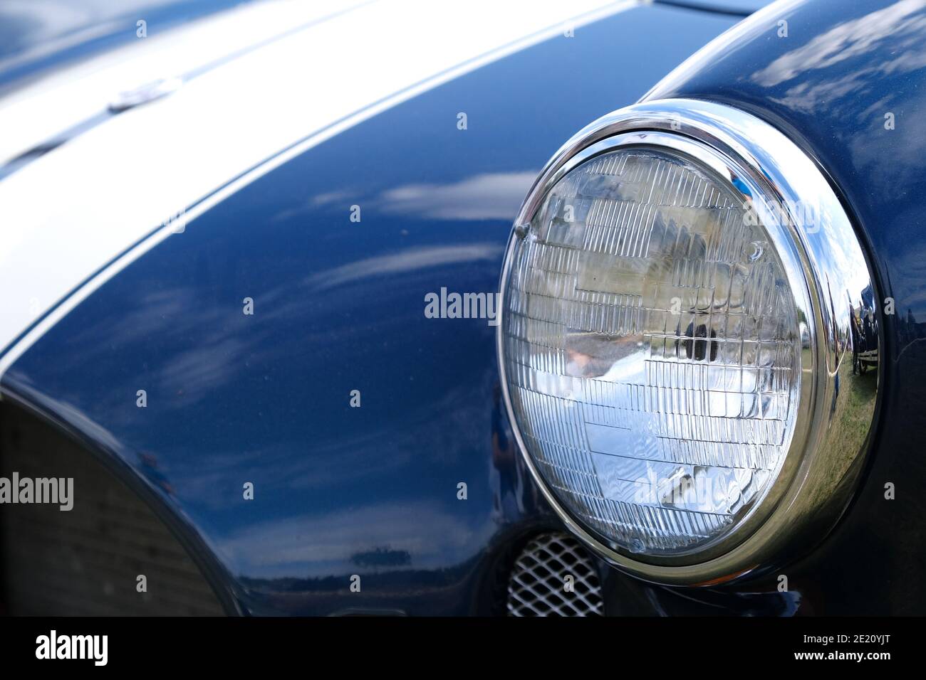 Headlight and hood of retro blue racing car ckose-up Stock Photo - Alamy