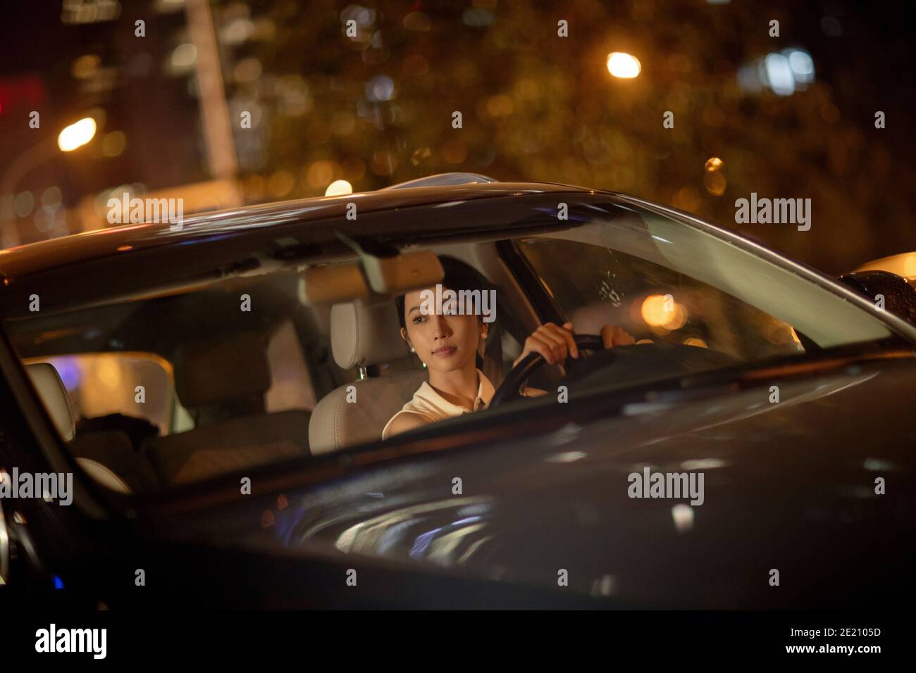 Driving at night young woman Stock Photo - Alamy