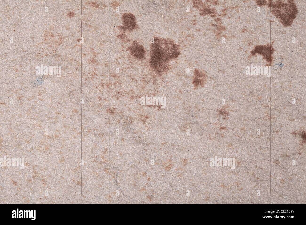 Brown abstract spots on textured fibrous paper or cardboard. Base for ...