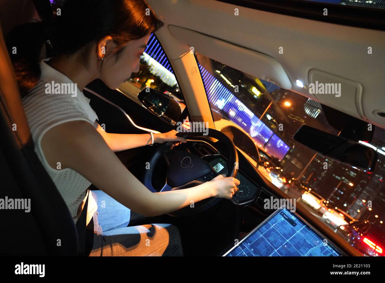 Driving at night young woman Stock Photo - Alamy