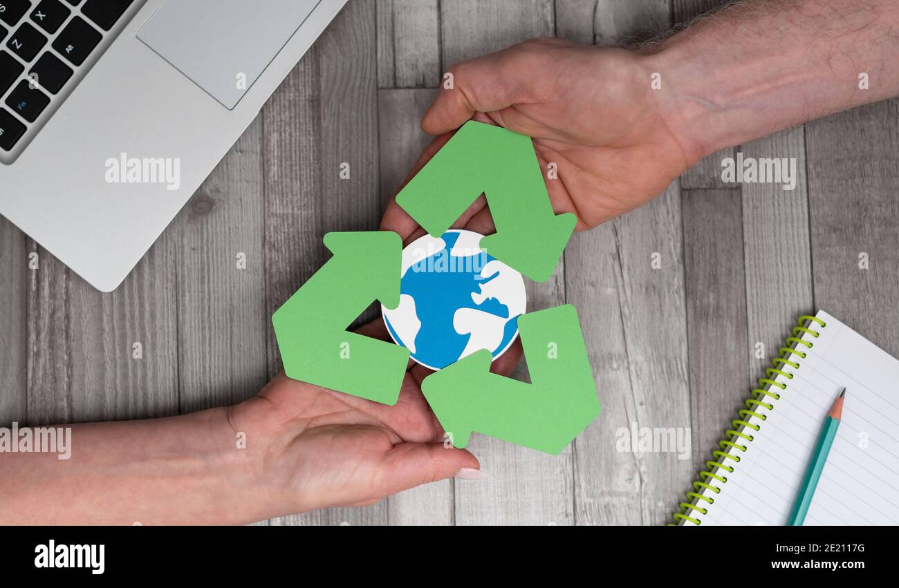Hands holding the earth with recycling symbol; Concept of global ...