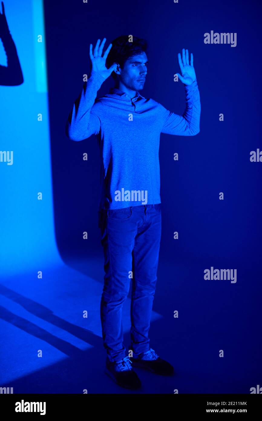 Studio Shot Of Man With Body Illuminated By Blue Light Stock Photo - Alamy