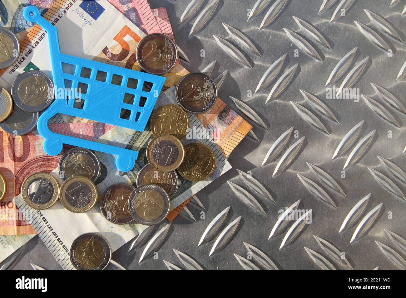 a small blue shopping cart on a checker plate Stock Photo - Alamy