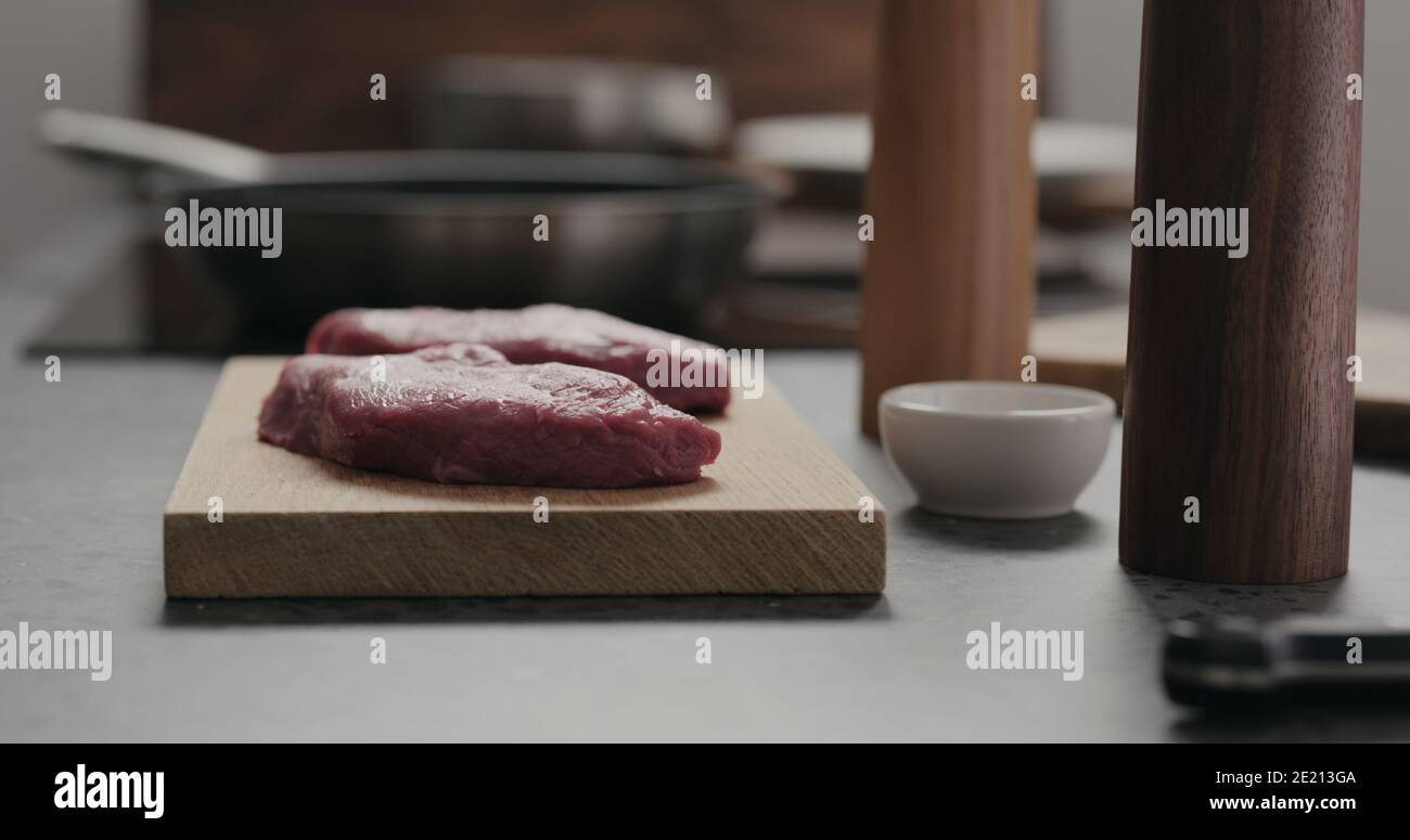 raw beef steak resting on oak board, wide photo Stock Photo - Alamy