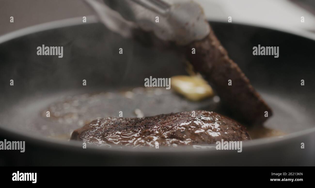 Man flipping beef steak hi-res stock photography and images - Alamy