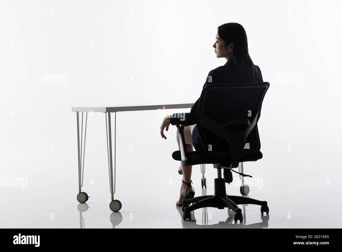 Ms sit at a desk in the business Stock Photo - Alamy