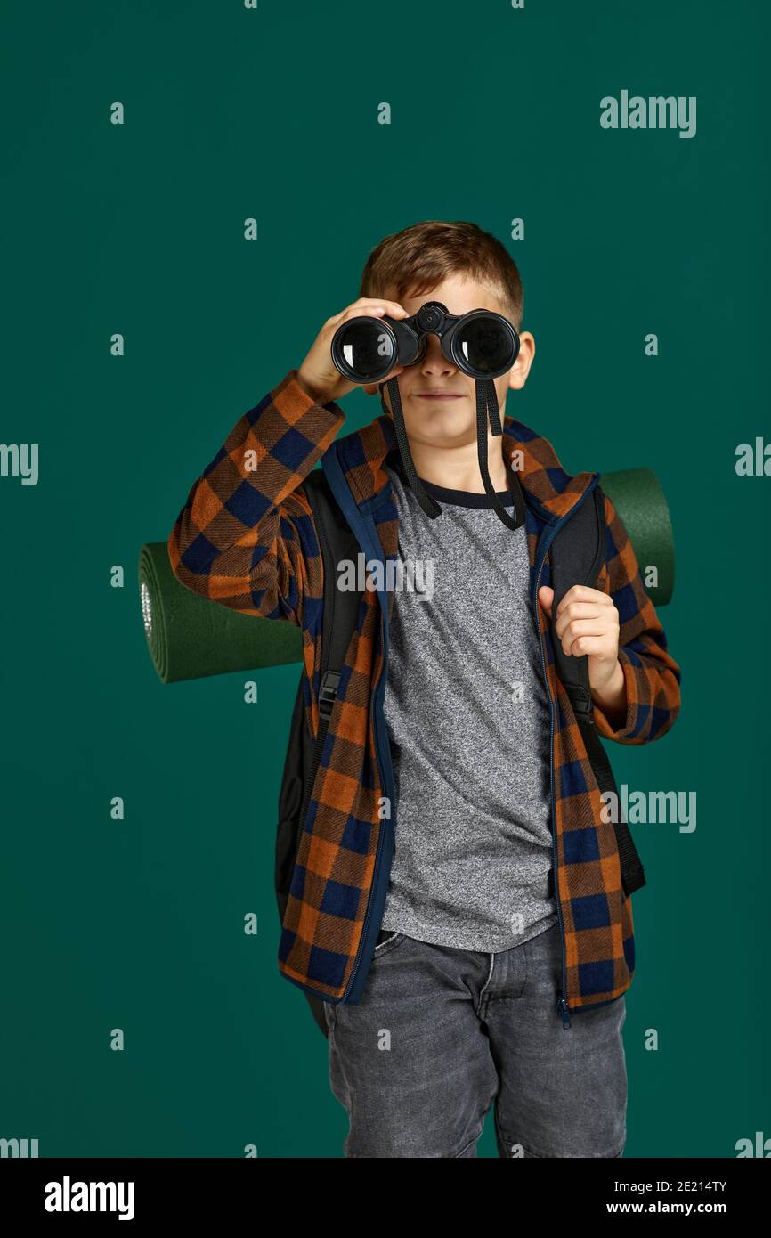 Little boy tourist with backpack looking through a binoculars. Little ...