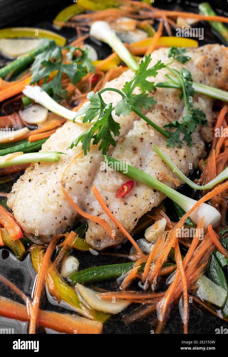 chinese cantonese style steamed spicy fish fillet with vegetables on ...