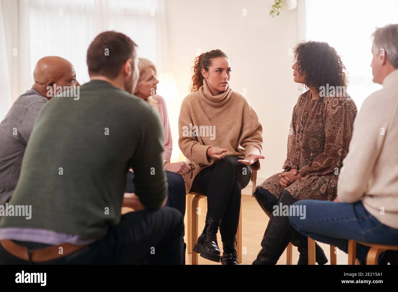 Woman Speaking At Support Group Meeting For Mental Health Or Dependency ...