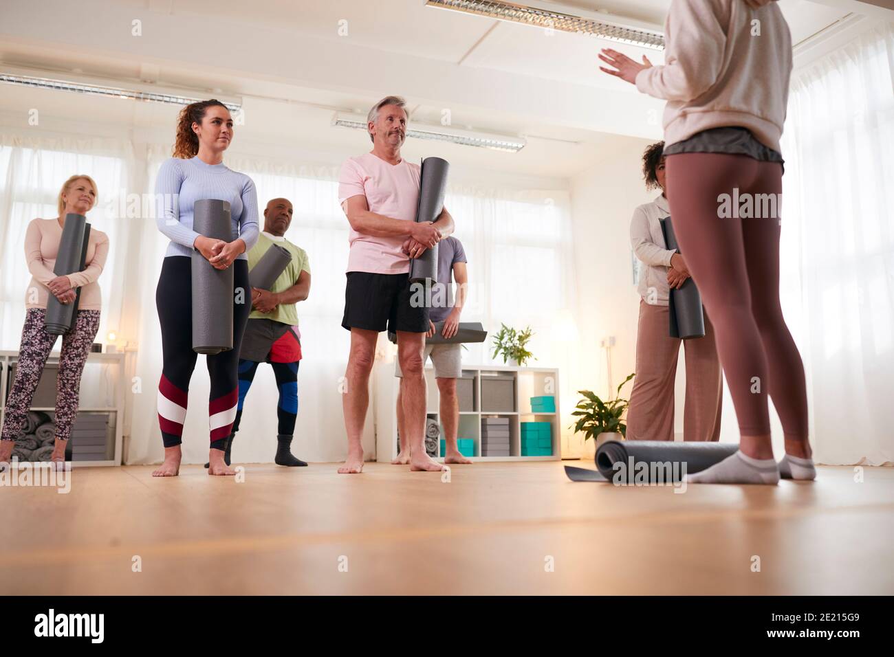 Group Of People In Exercise Clothing Meeting For Fitness Or Yoga Class ...