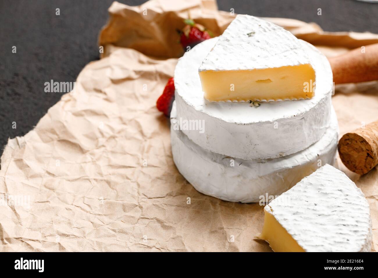 Pieces of camembert cheese on crumpled paper Stock Photo - Alamy