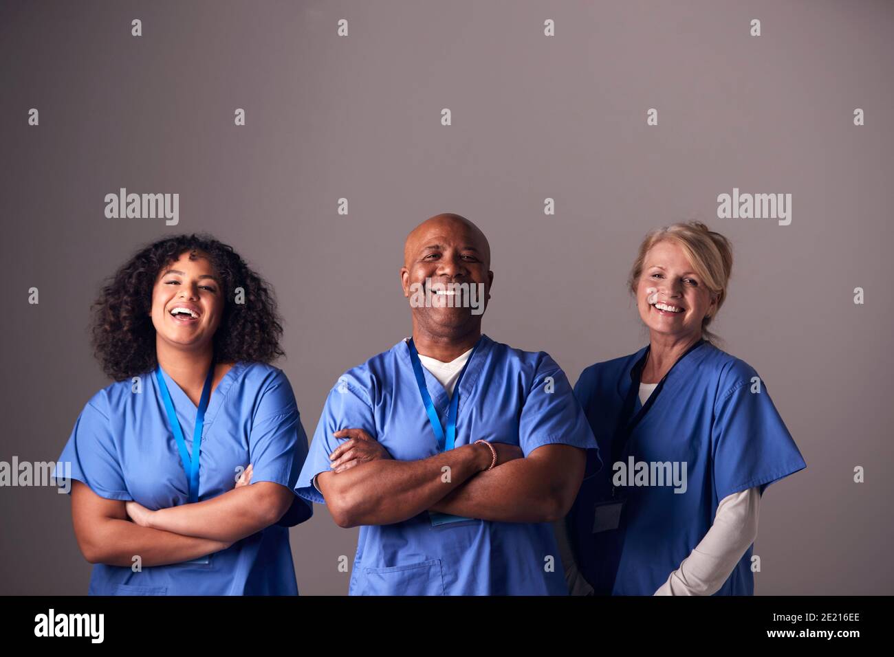 Studio Portrait Of Three Members Of Surgical Team Wearing Scrubs ...
