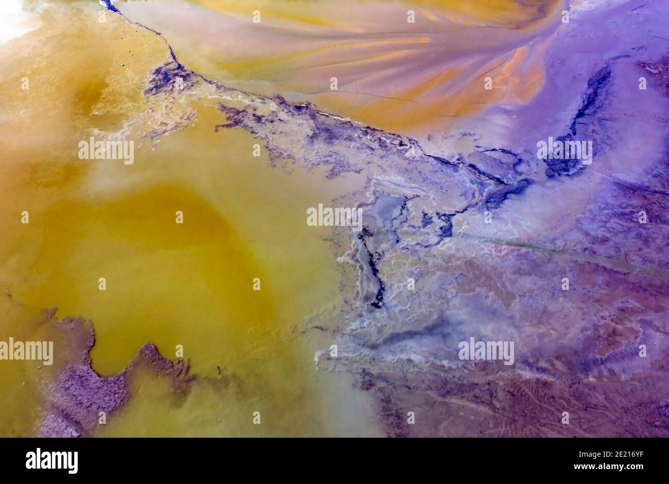 Beautiful aerial pattern of colorful water and mud, shot with a drone ...
