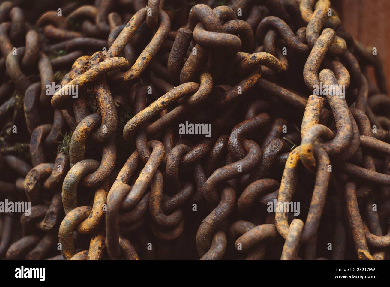 Closeup of old weathered rusty giant metallic chains on each other in ...