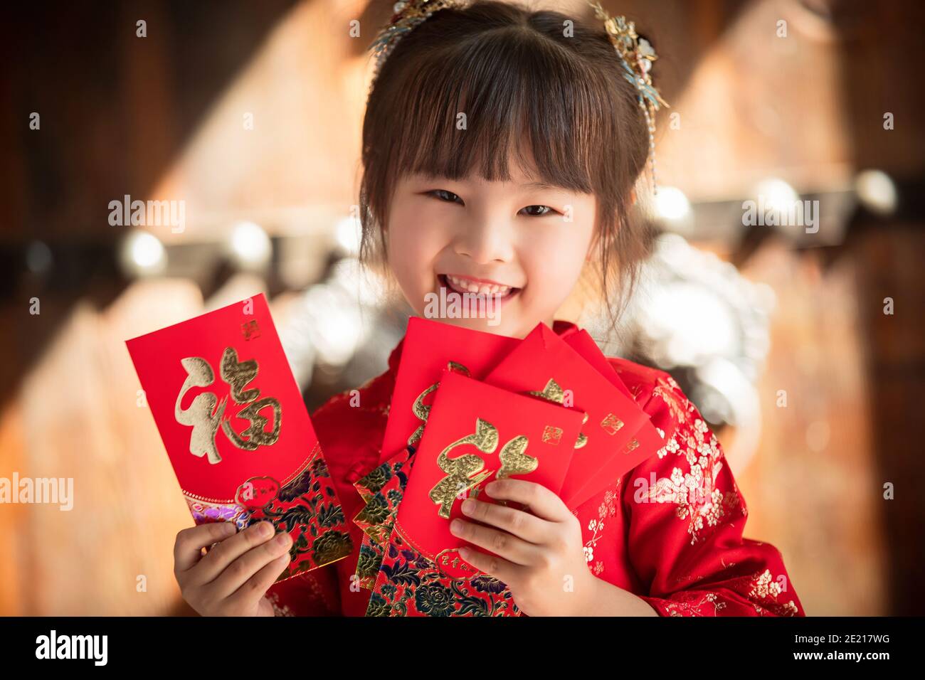 Cute girl with a red envelope Stock Photo - Alamy