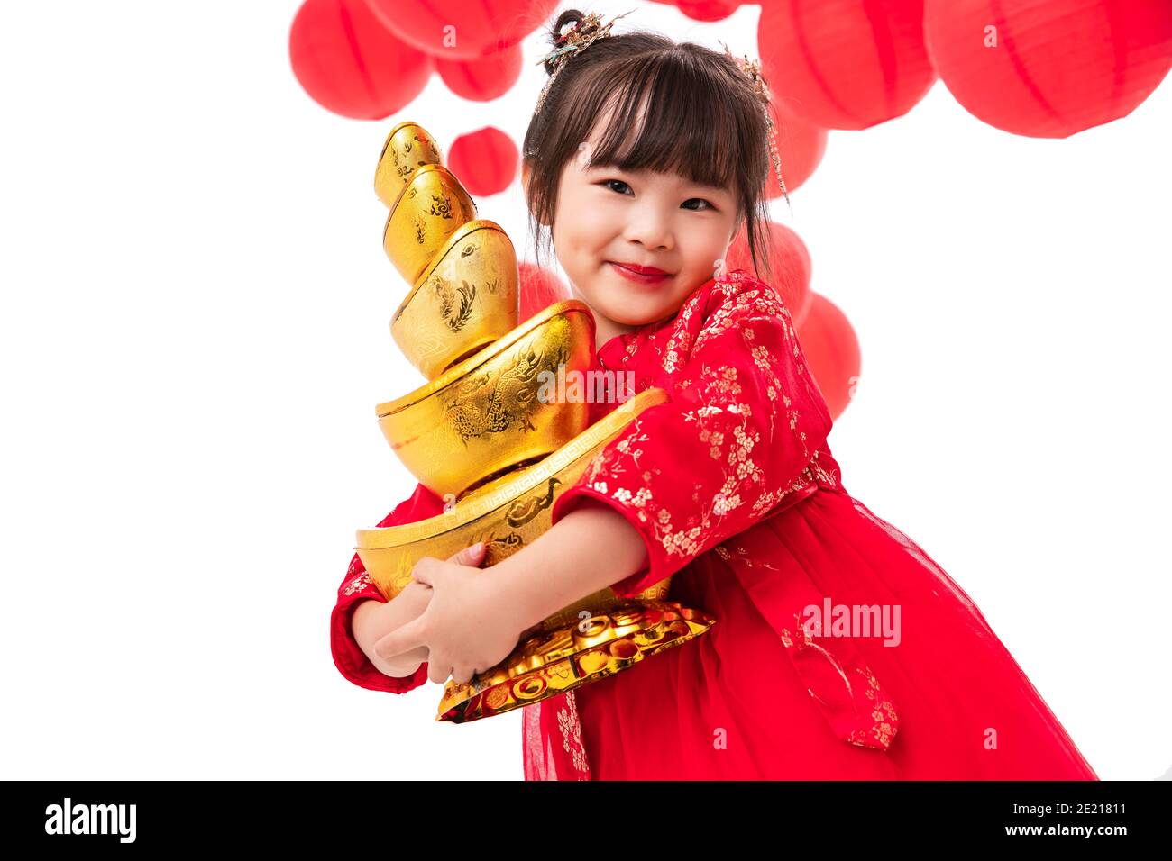 Lovely little girl holding the gold ingot Stock Photo - Alamy