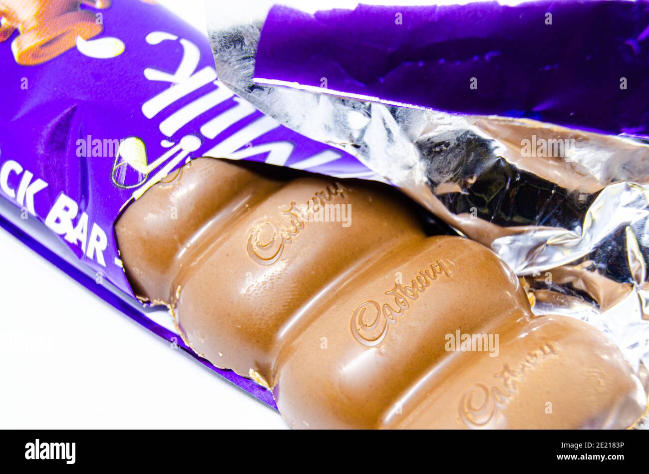 A bar of Cadbury's Dairy Milk chocolate partly unwrapped Stock Photo ...