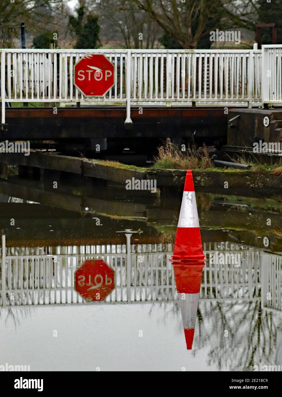 Traffic cone stood on a frozen canal hi-res stock photography and ...