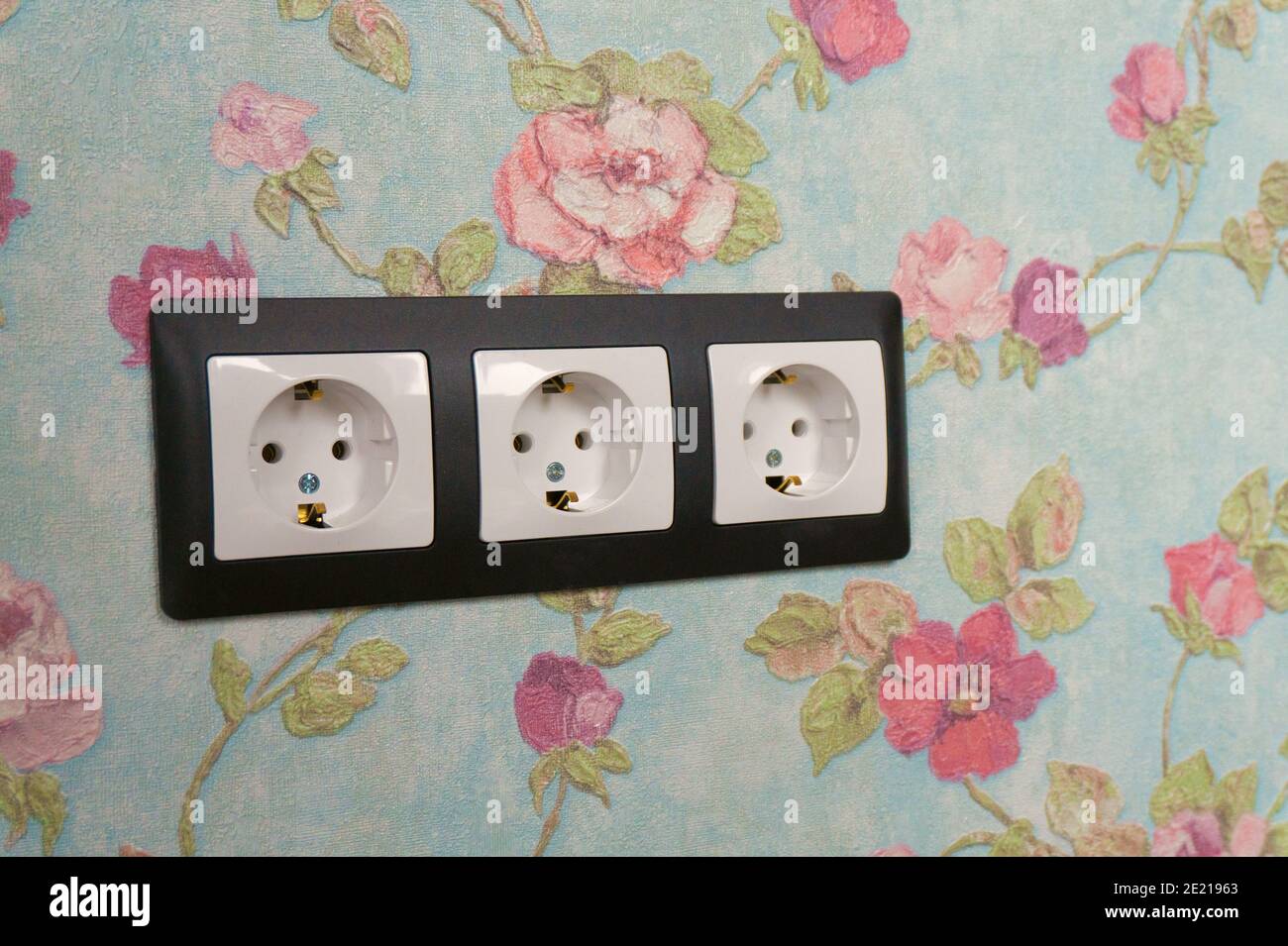 white electrical outlets with black frames on the background of ...