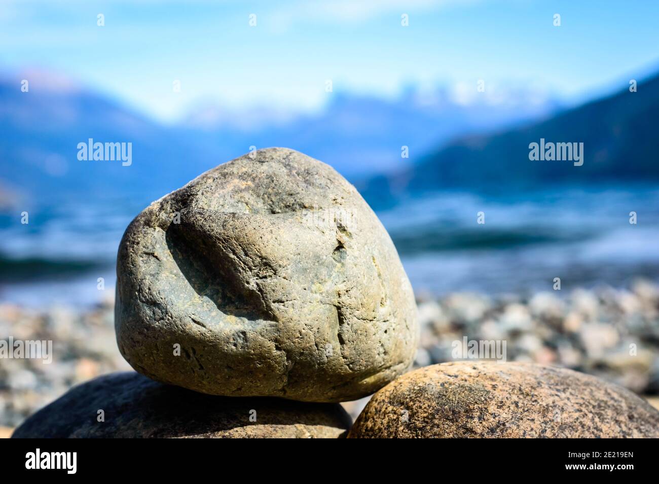 Selective focus closeup of stacked rocks on the rocky river Stock Photo ...