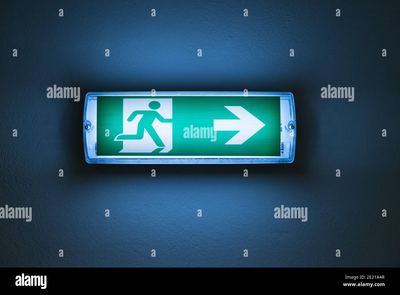 Isolated shot of an Emergency Exit sign on the blue wall Stock Photo ...