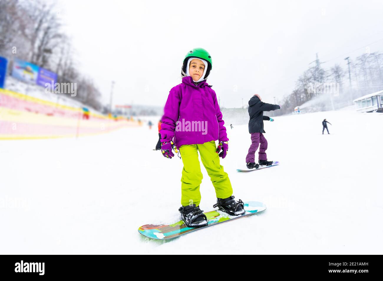 Little Cute Girl Snowboarding at ski resort in sunny winter day Stock ...