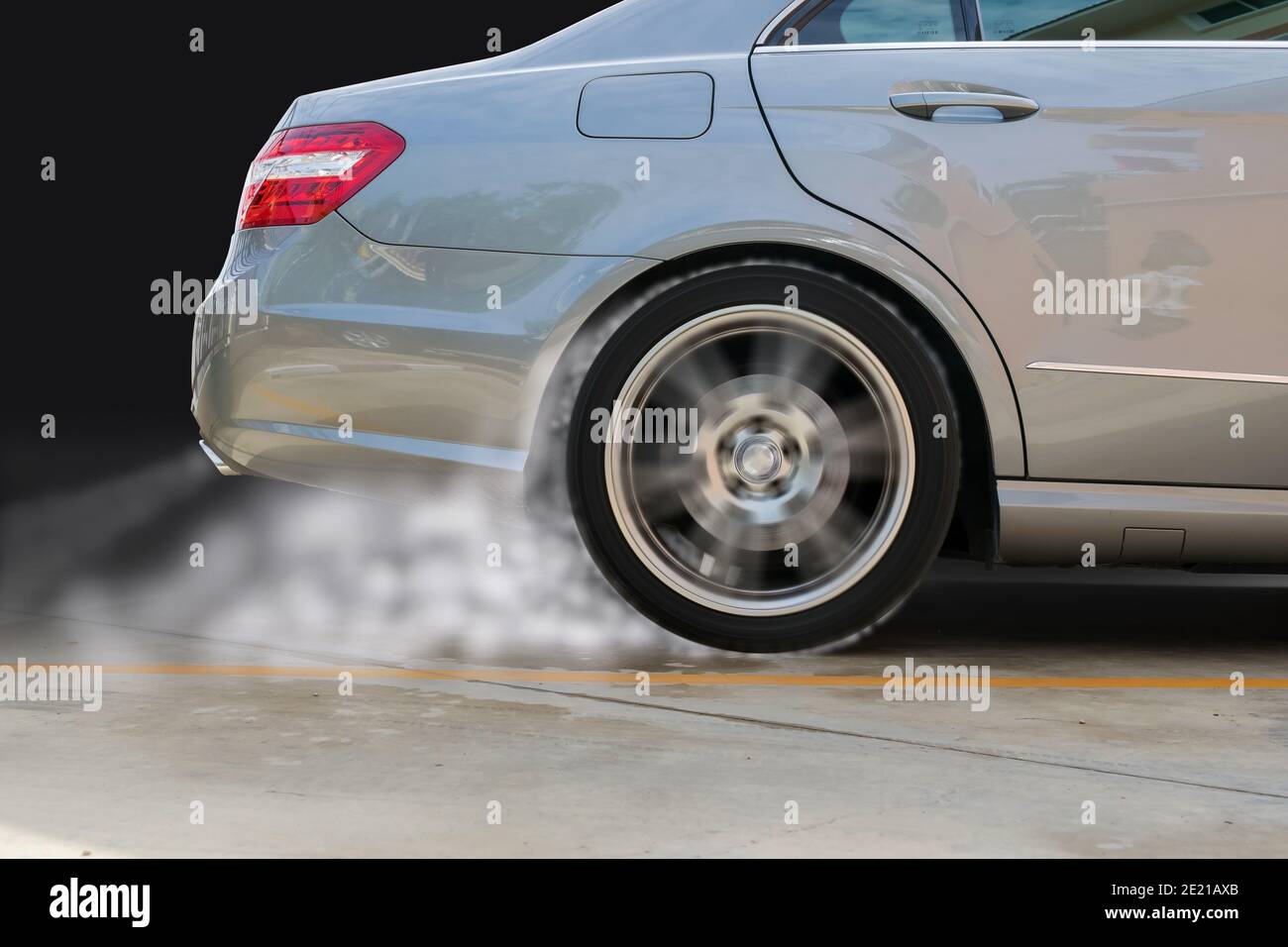 Closeup of the rear wheel of a car that spin and cause smoke Stock ...