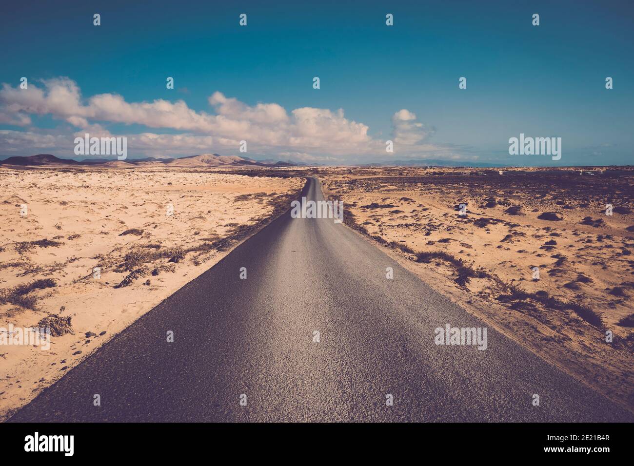 Long straight asphalt road with sand and rocks desert around - travel ...