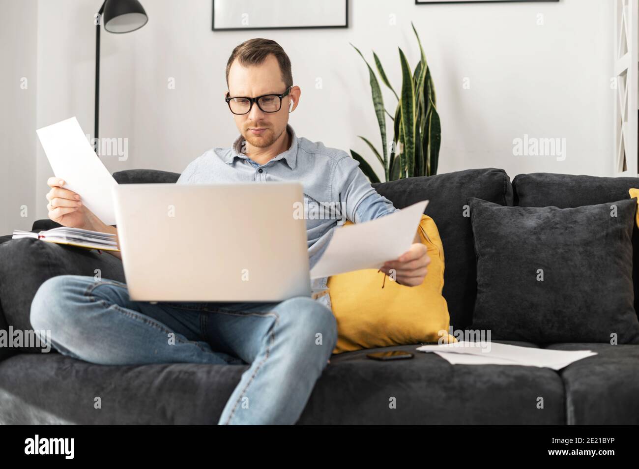 A freelancer with a laptop doing paperwork Stock Photo - Alamy
