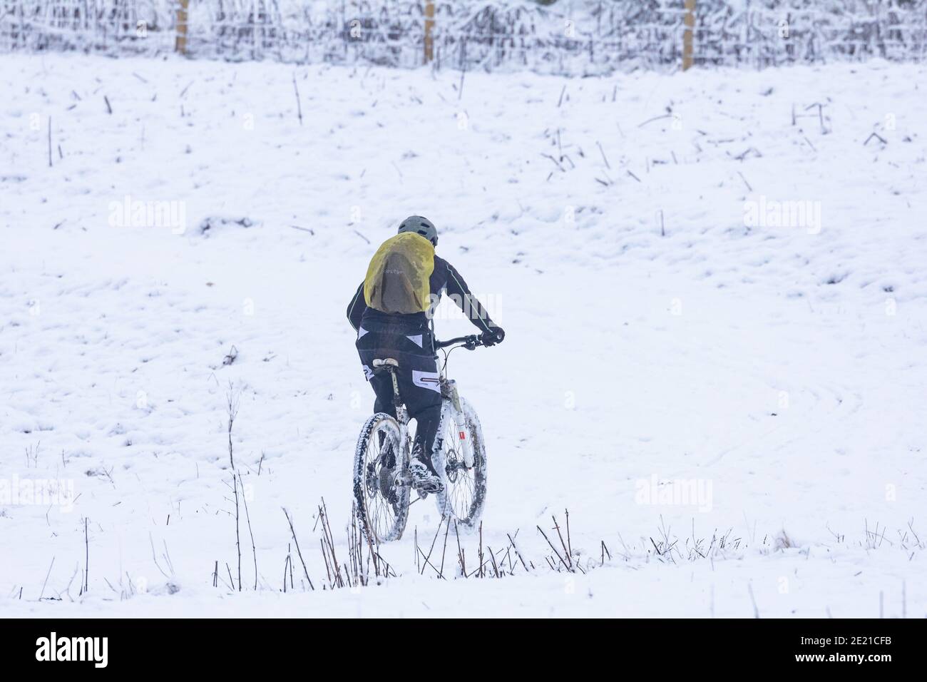 A cyclist in snow Stock Photo - Alamy