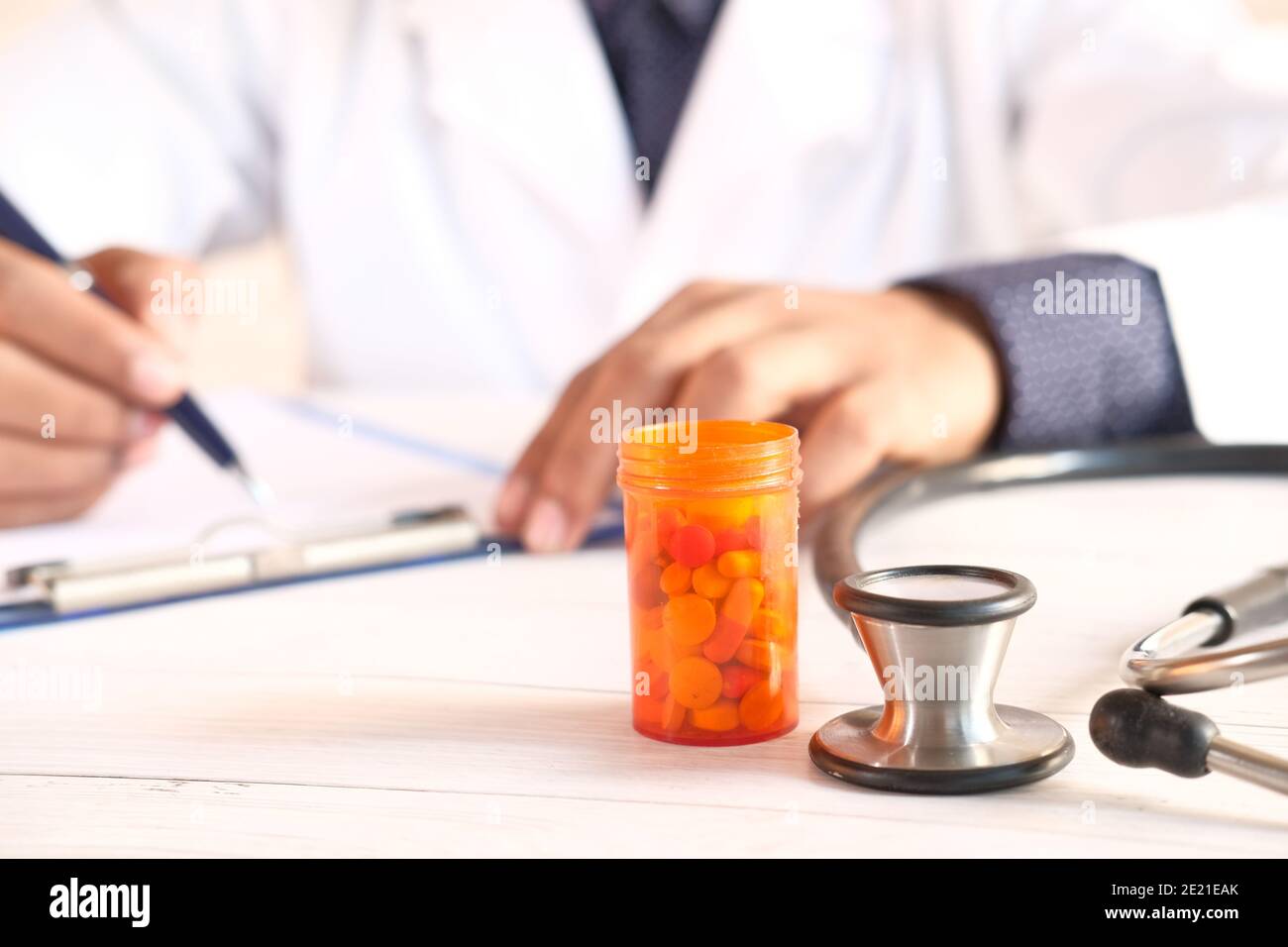 doctor hand writing prescription on desk, close up Stock Photo - Alamy