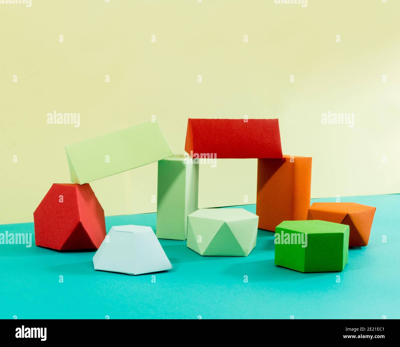 Shot of different geometric figures made of paper of various colors on ...