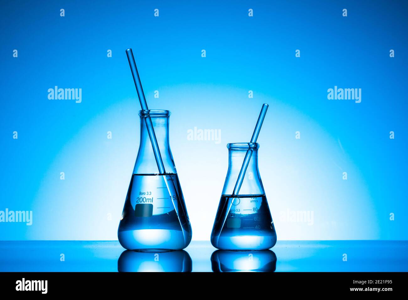 Two conical flasks with glass mixing tubes at a lab Stock Photo - Alamy