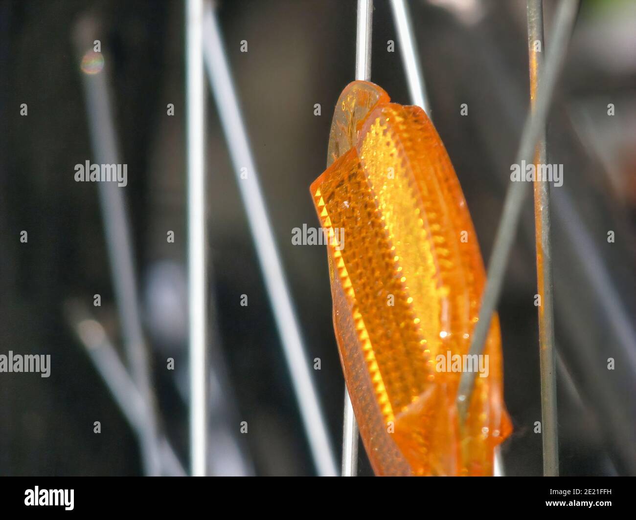 Selective focus shot of an orange reflectorize on a bicycle wheel Stock ...