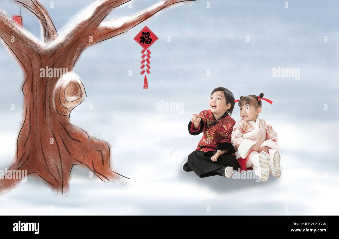 Happy children playing sitting under the tree Stock Photo - Alamy